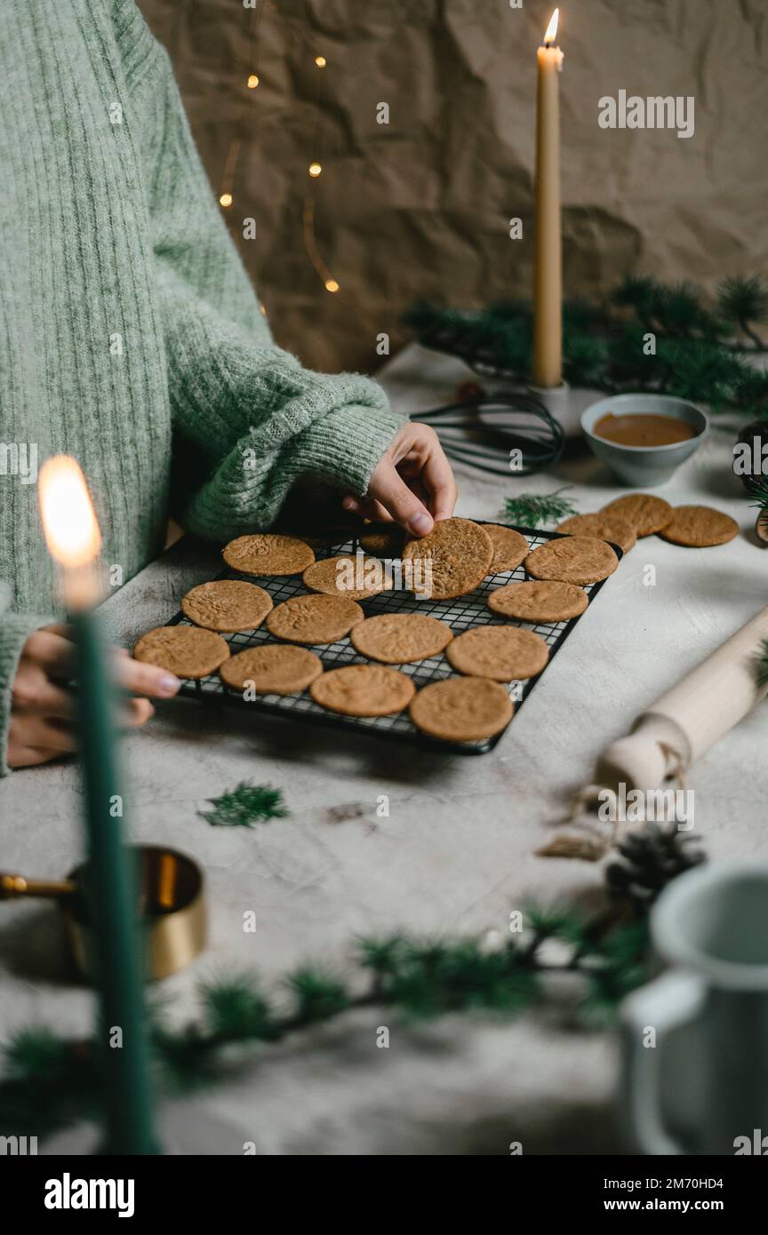 Baking Christmas almond butter Cookies with candle light in a moody ...