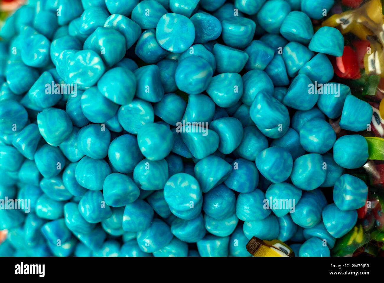 many colored marmalade candies laid out on a flat surface; dessert for ...