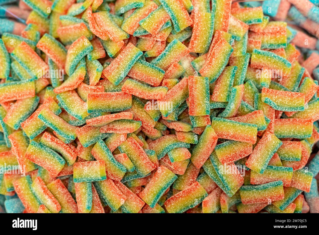 many colored marmalade candies laid out on a flat surface; dessert for ...