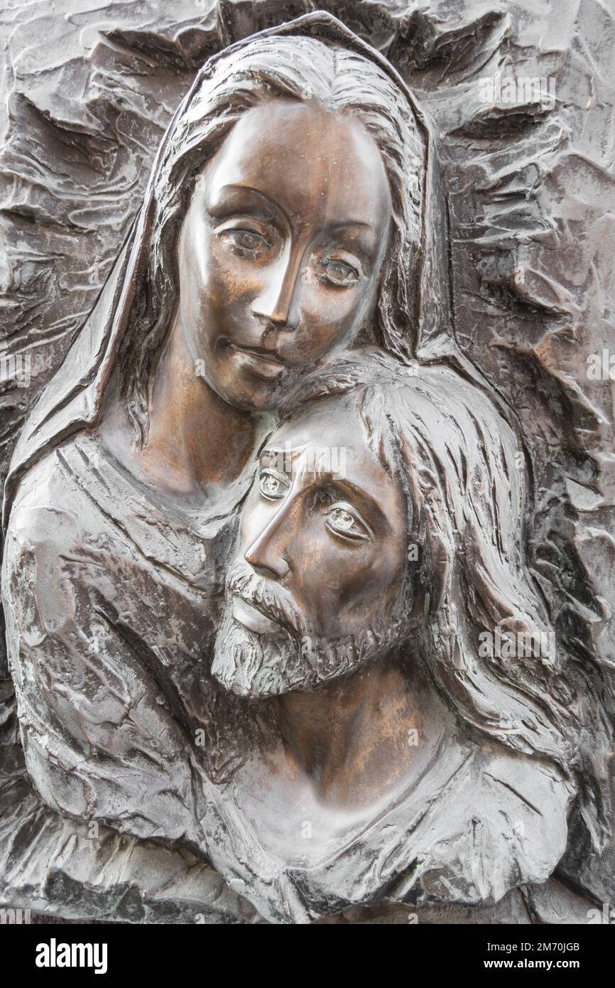 Bas-relief in bronze. Faces of Holy Mary mother and Jesus Christ after ...
