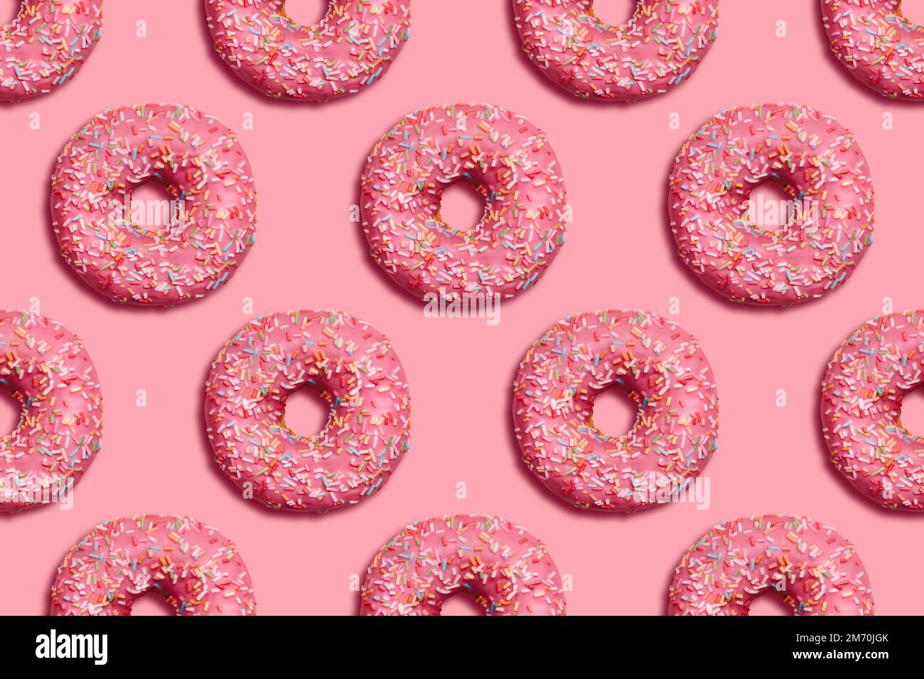 Flat lay donuts seamless pattern on pink background. Sweet glazed ...
