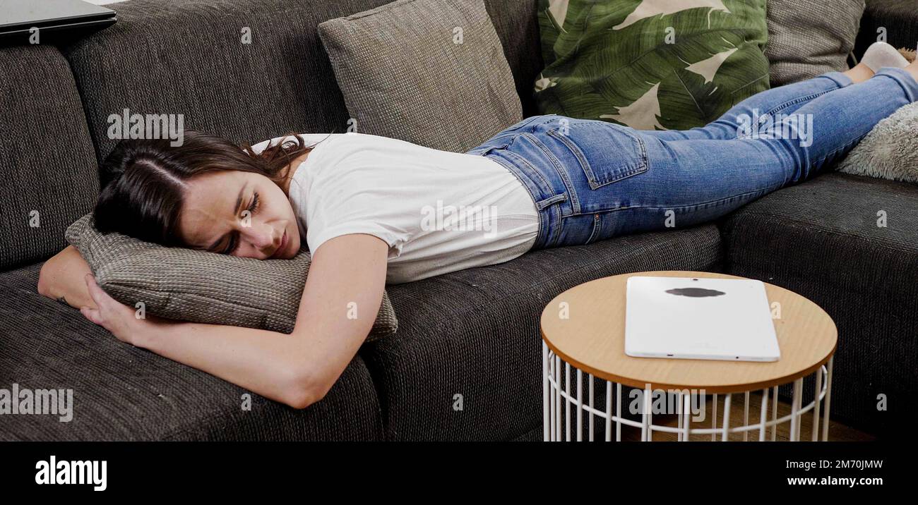 Young woman is sleeping on the couch Stock Photo - Alamy