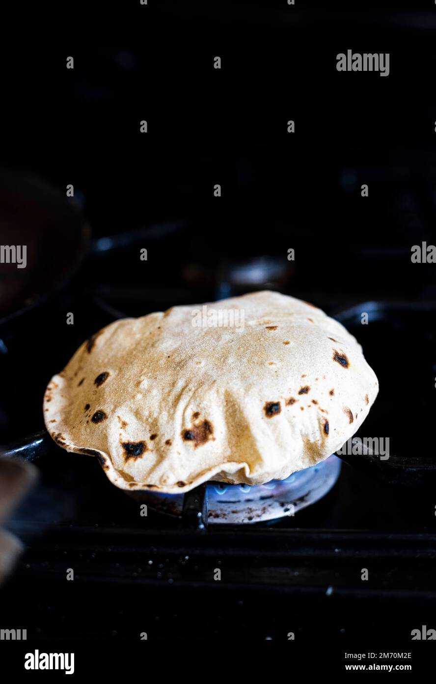 fresh roti cooking on a flame Stock Photo - Alamy