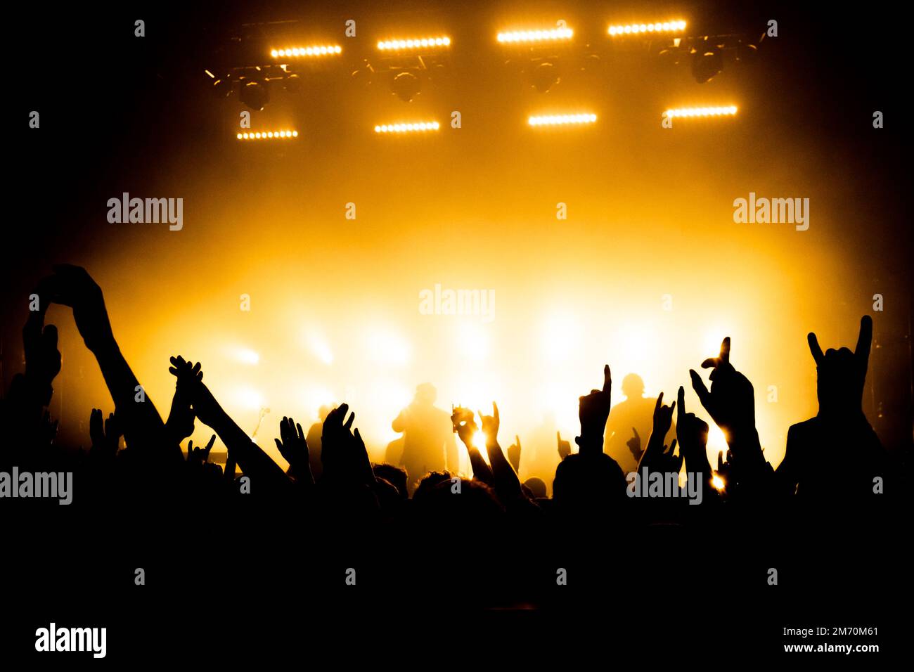 Party people wave their hands from side to side at a live concert at ...