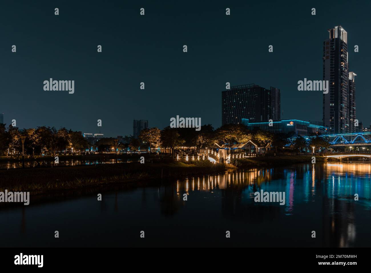 A low-angle night view of high-rise buildings in Fuzhou with a lake ...