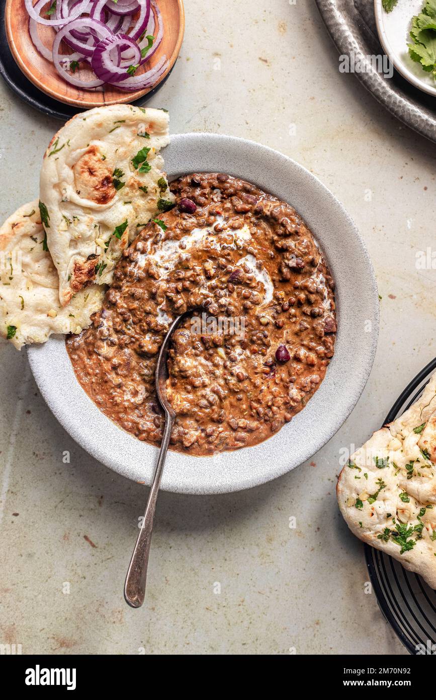 Bowl of Dal Makhani served with naan bread Stock Photo - Alamy