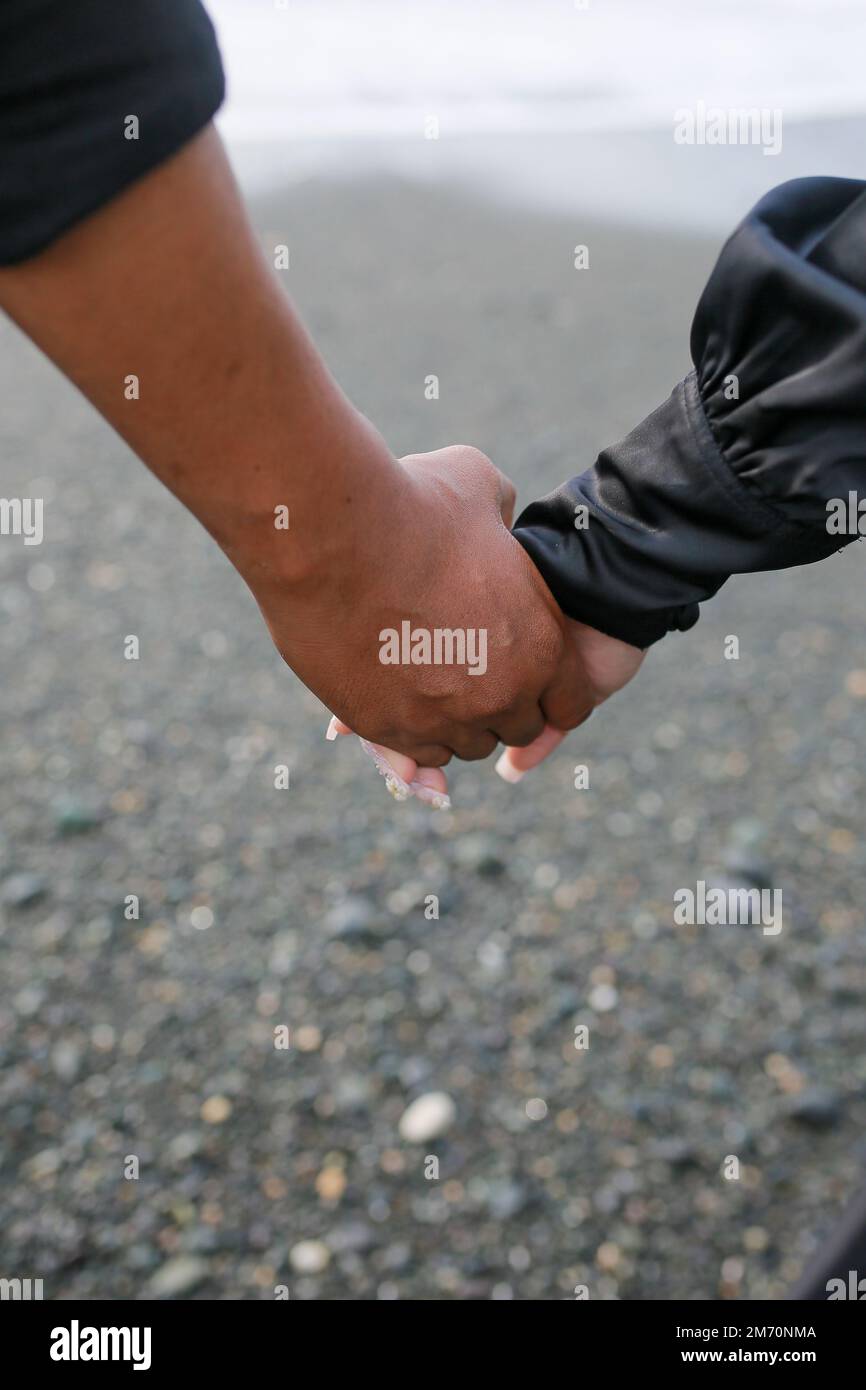 a couple's hands clasped together Stock Photo - Alamy
