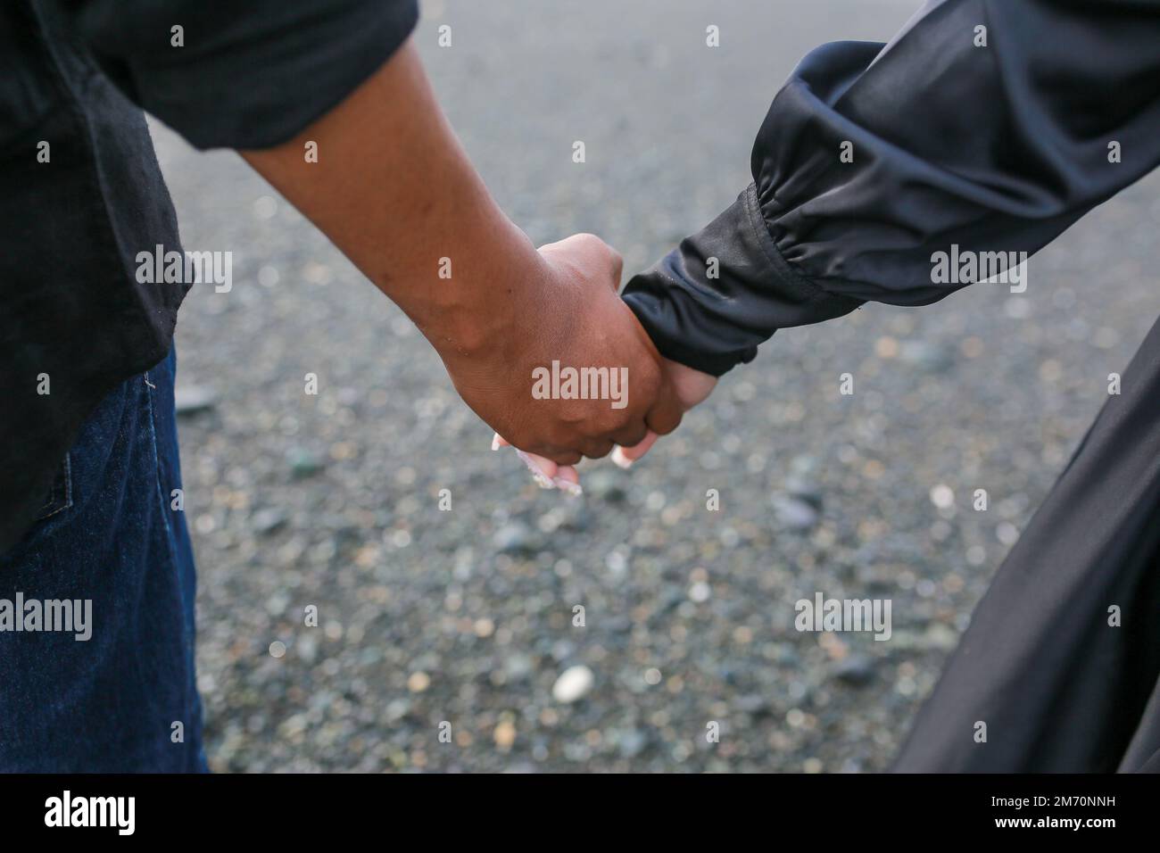 a couple's hands clasped together Stock Photo - Alamy