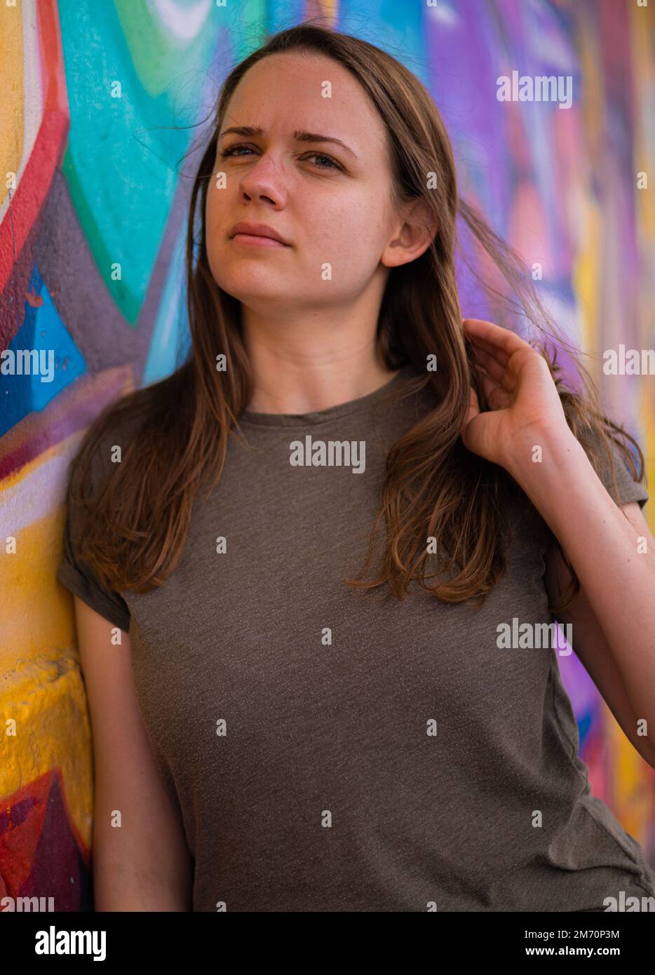 Street style photo shoot with a young pretty woman in the colorful ...