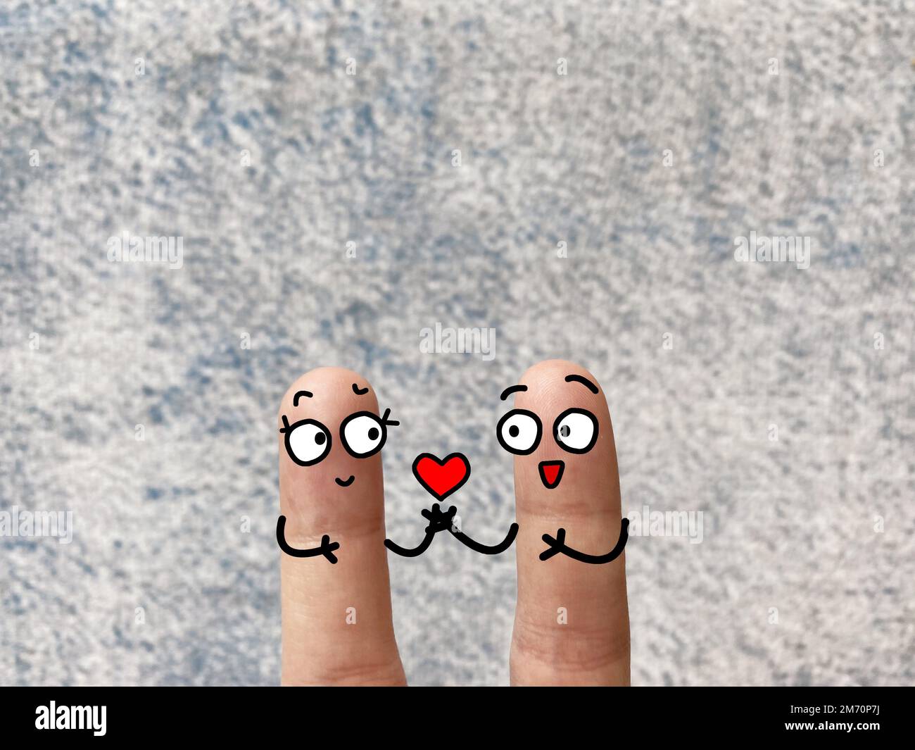 Two fingers are decorated as two person. One of them is asking another if she will marry him ...