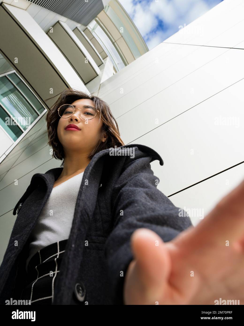 Up Angle Shot of Beautiful Young Asian Woman With Hand Reaching for the ...
