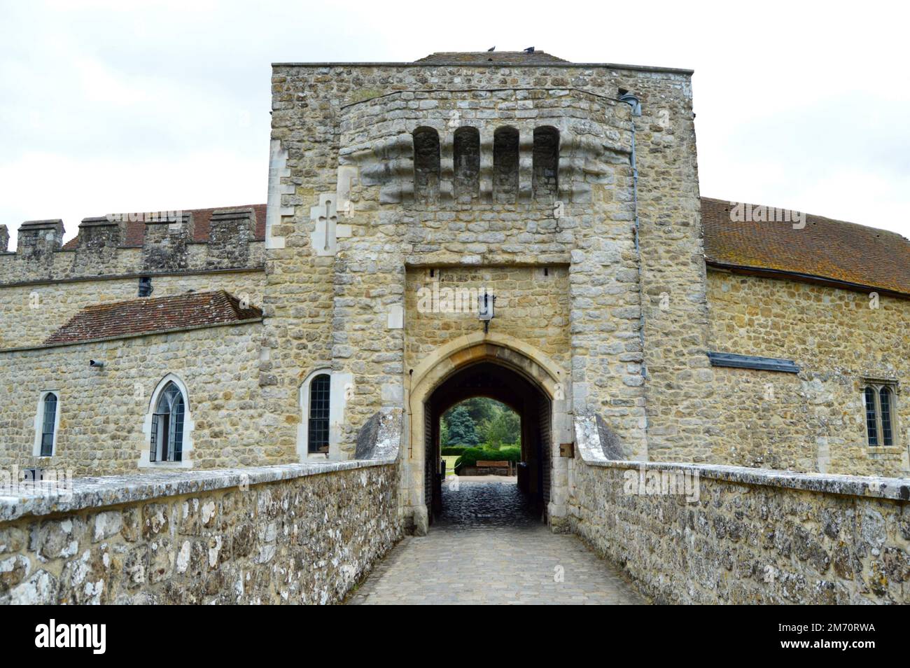 A stone bridge leading into the gatehouse of a medieval castle Stock ...