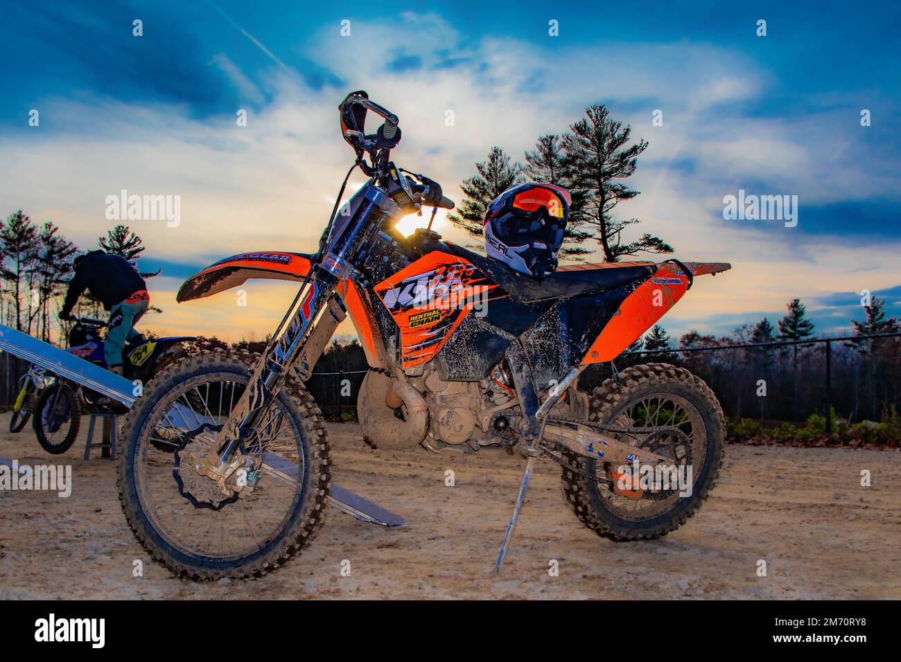 A closeup of a red dirt bike on the sunset background sky Stock Photo ...