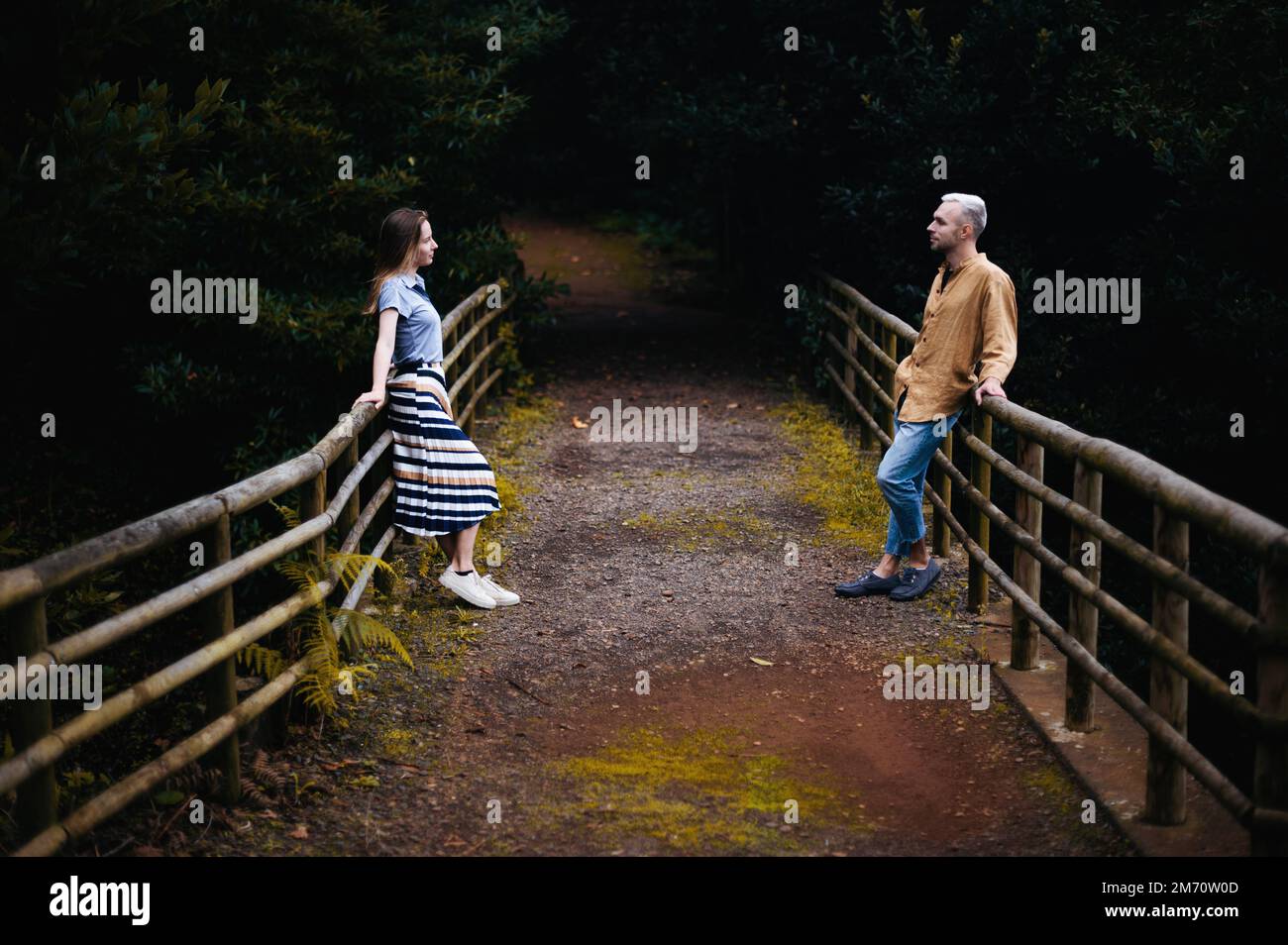 A romantic photo of a young couple in a beautiful autumn park, standing ...
