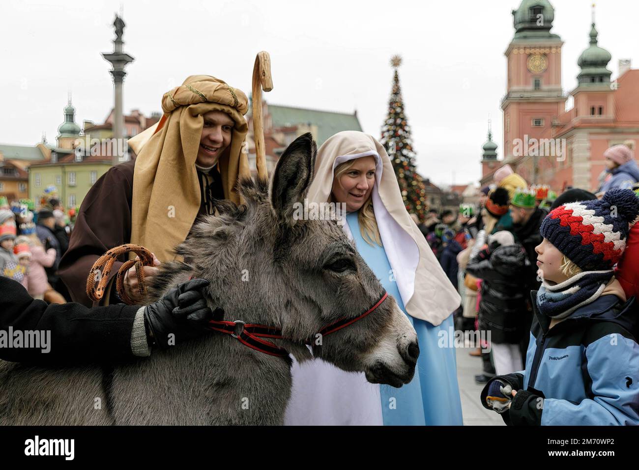 Warsaw, Poland. 06th Jan, 2023. A little boy (R) reacts to the donkey ...