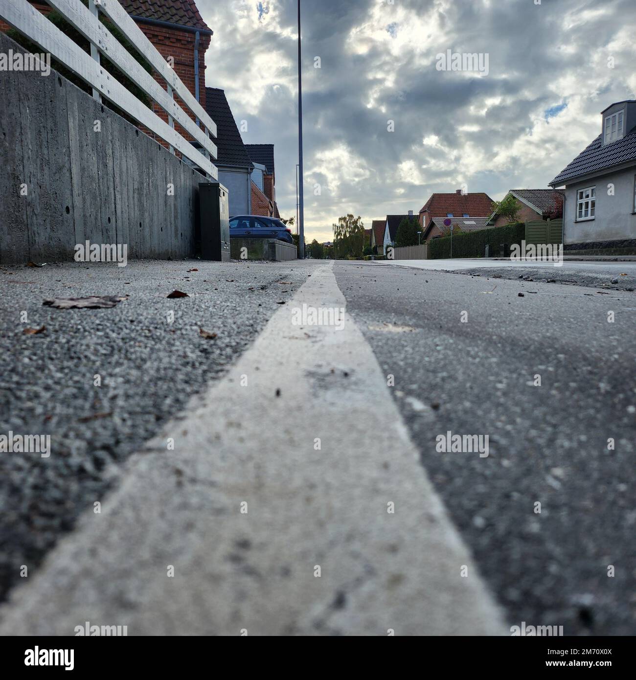 The line on the road that separates bikes from pedestrians in small ...