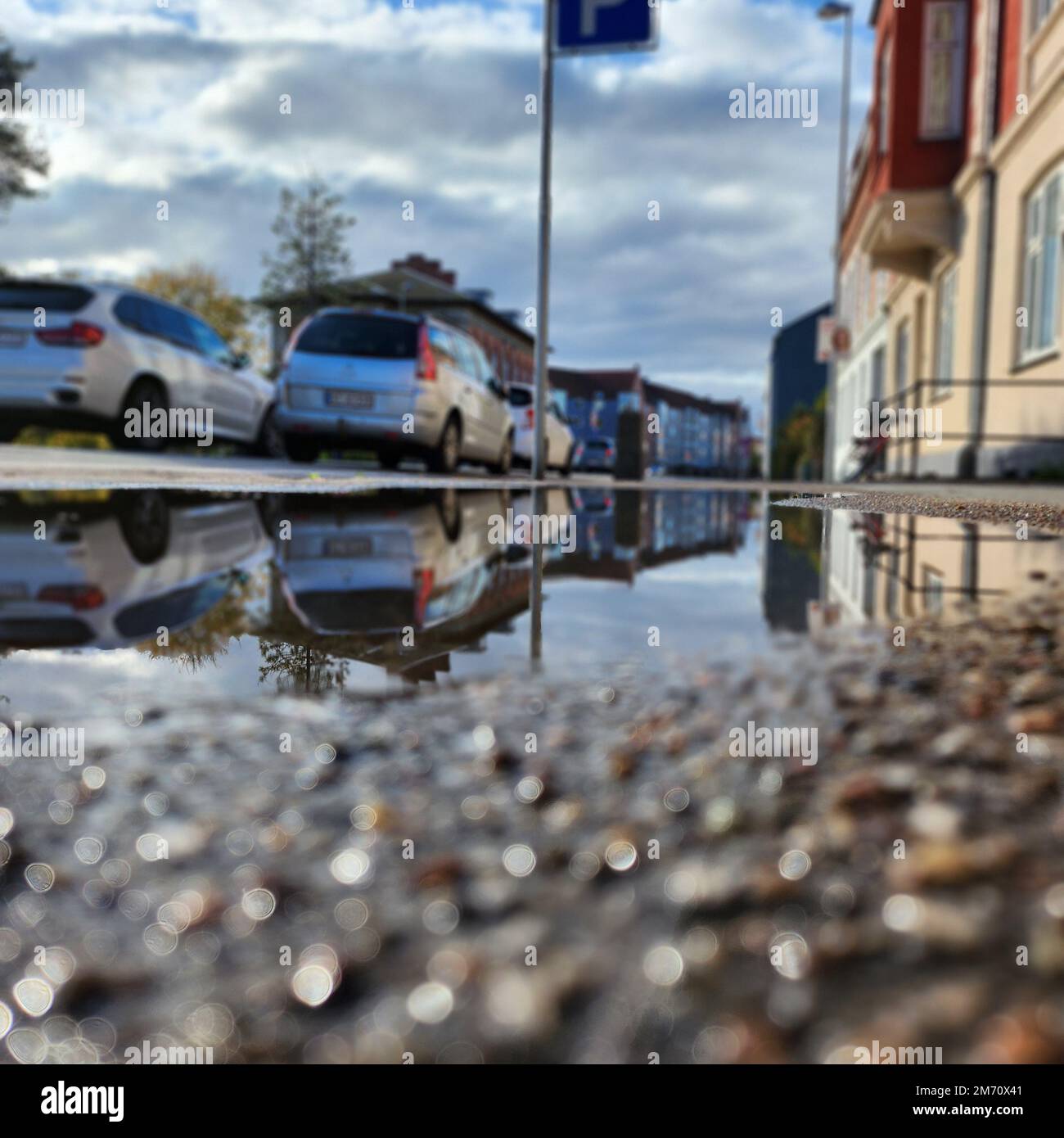 The view from the ground on a bigger danish street with a car driving ...