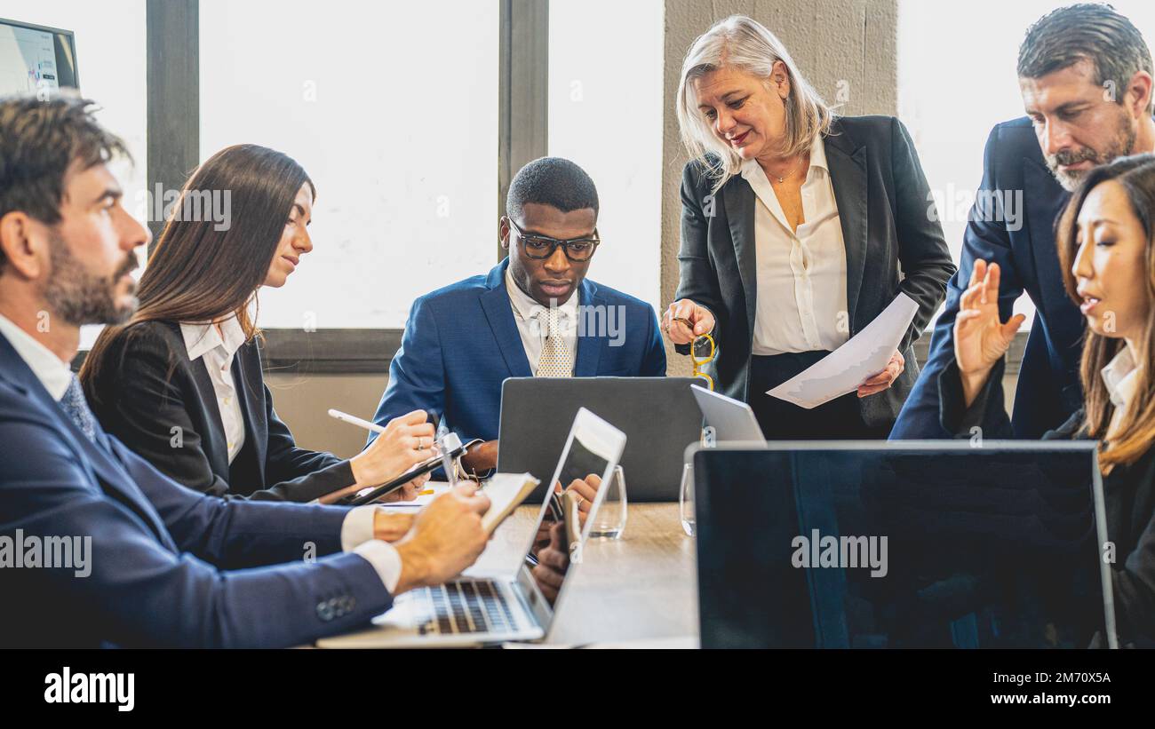 Multiracial business team working together and sharing achievement ...