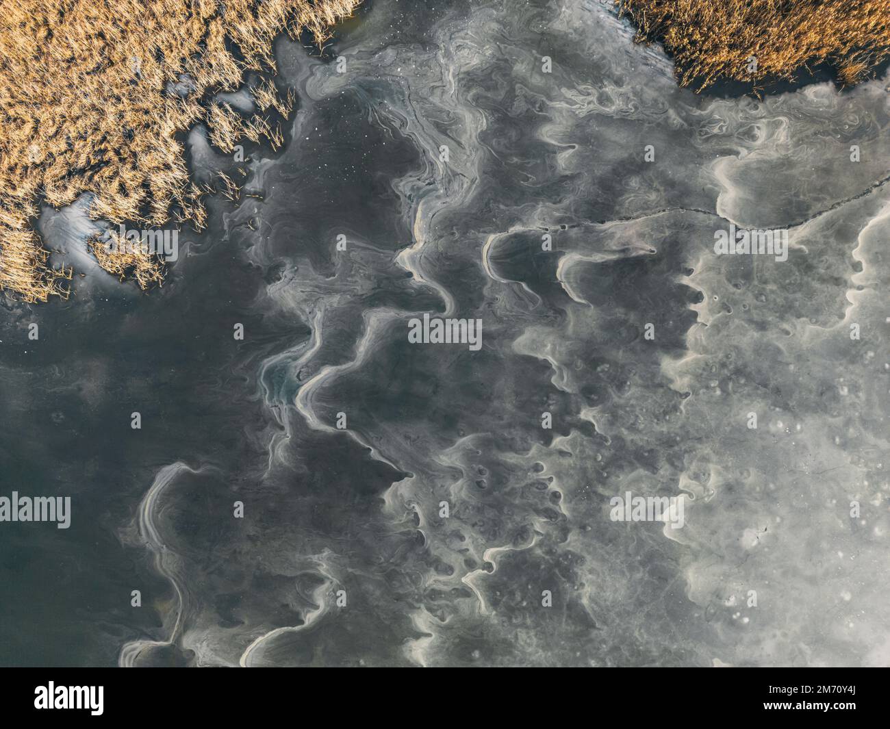 Aerial view of a frozen lake. Ice sheet background. Frozen waves on the ...