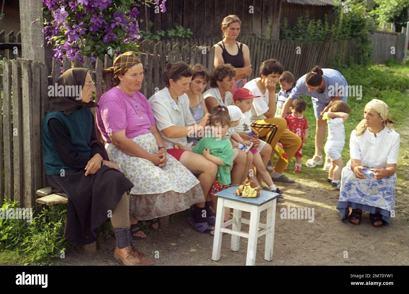 Mures County, Romania, approx. 2001. Local women and children sitting ...
