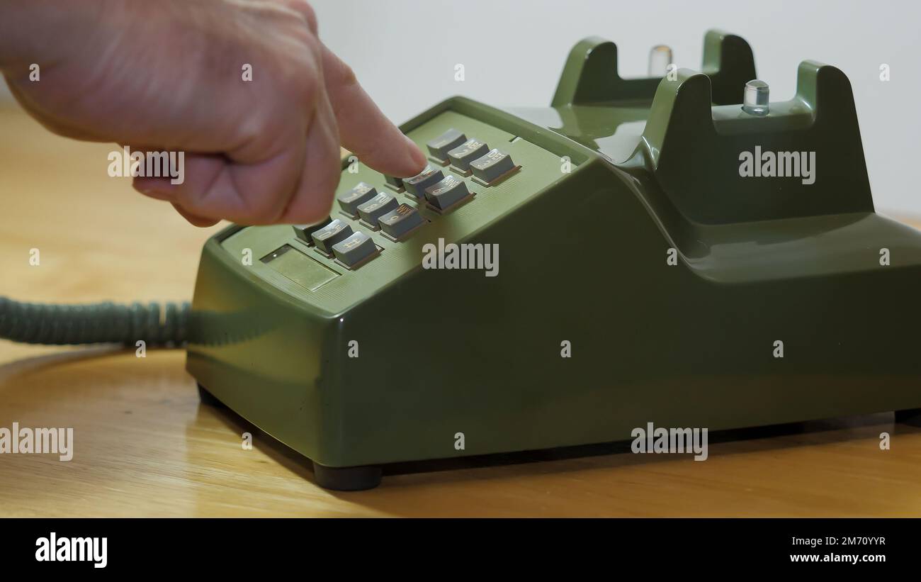Dialing retro push button rotary dial telephone. Vintage avocado green ...