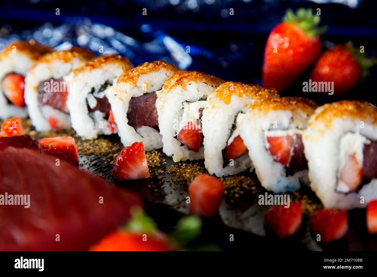 Tuna Uramaki with strawberries. Sushi rice combined with premium tuna ...