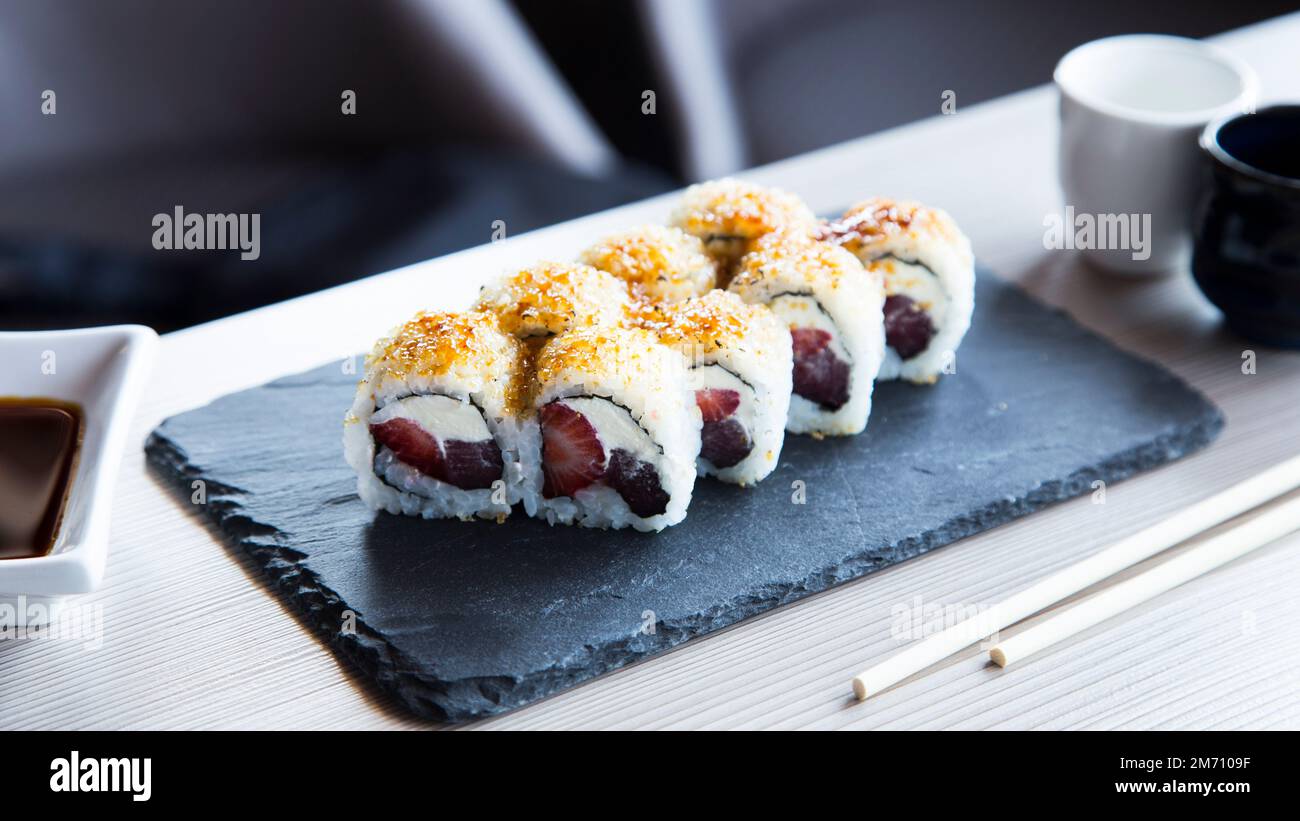 Tuna Uramaki with strawberries. Sushi rice combined with premium tuna ...