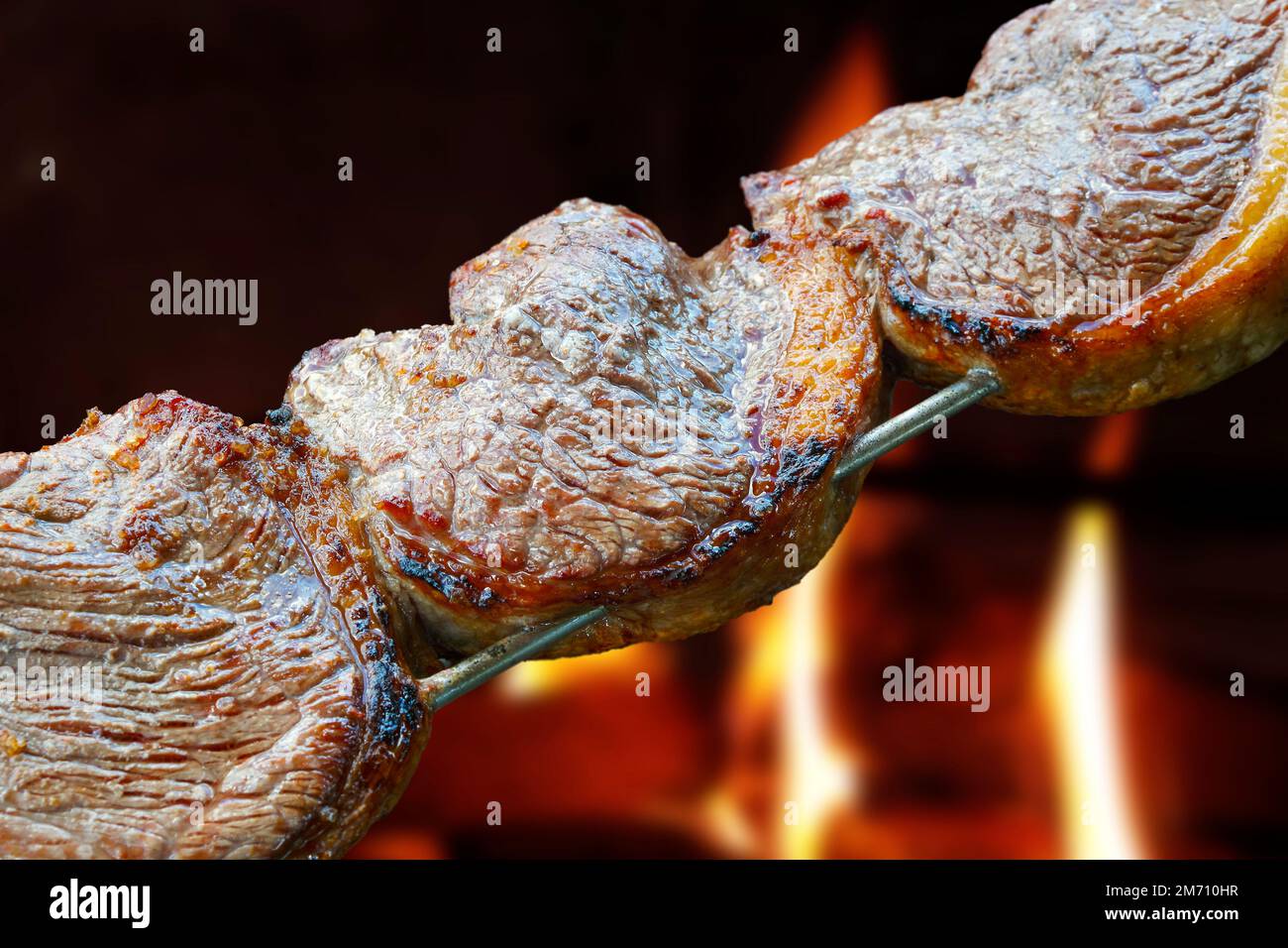 Steak rotisserie at the steakhouse, sliced picanha Stock Photo - Alamy