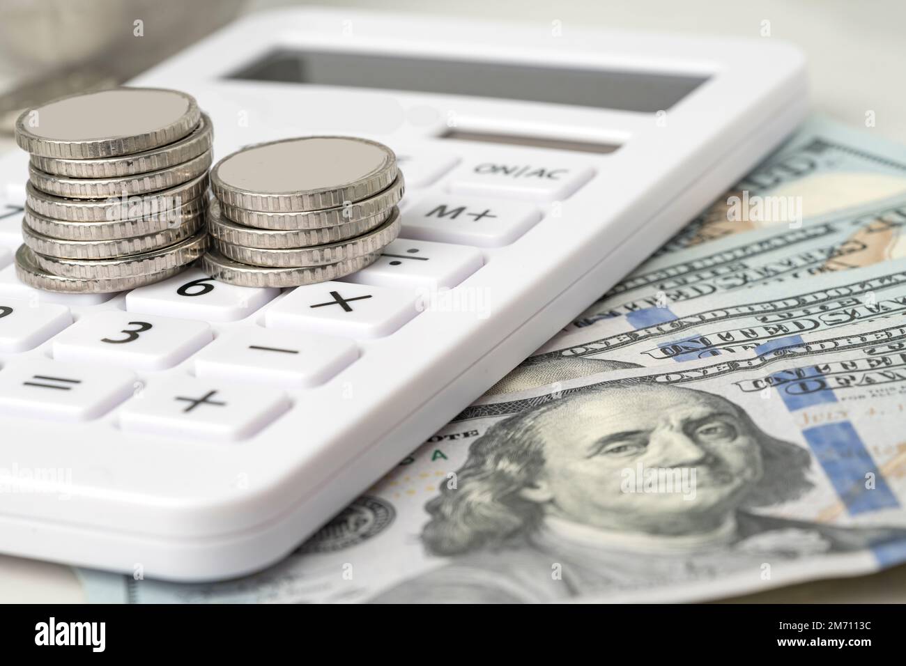 White calculator with American currency . A concept for recording ...