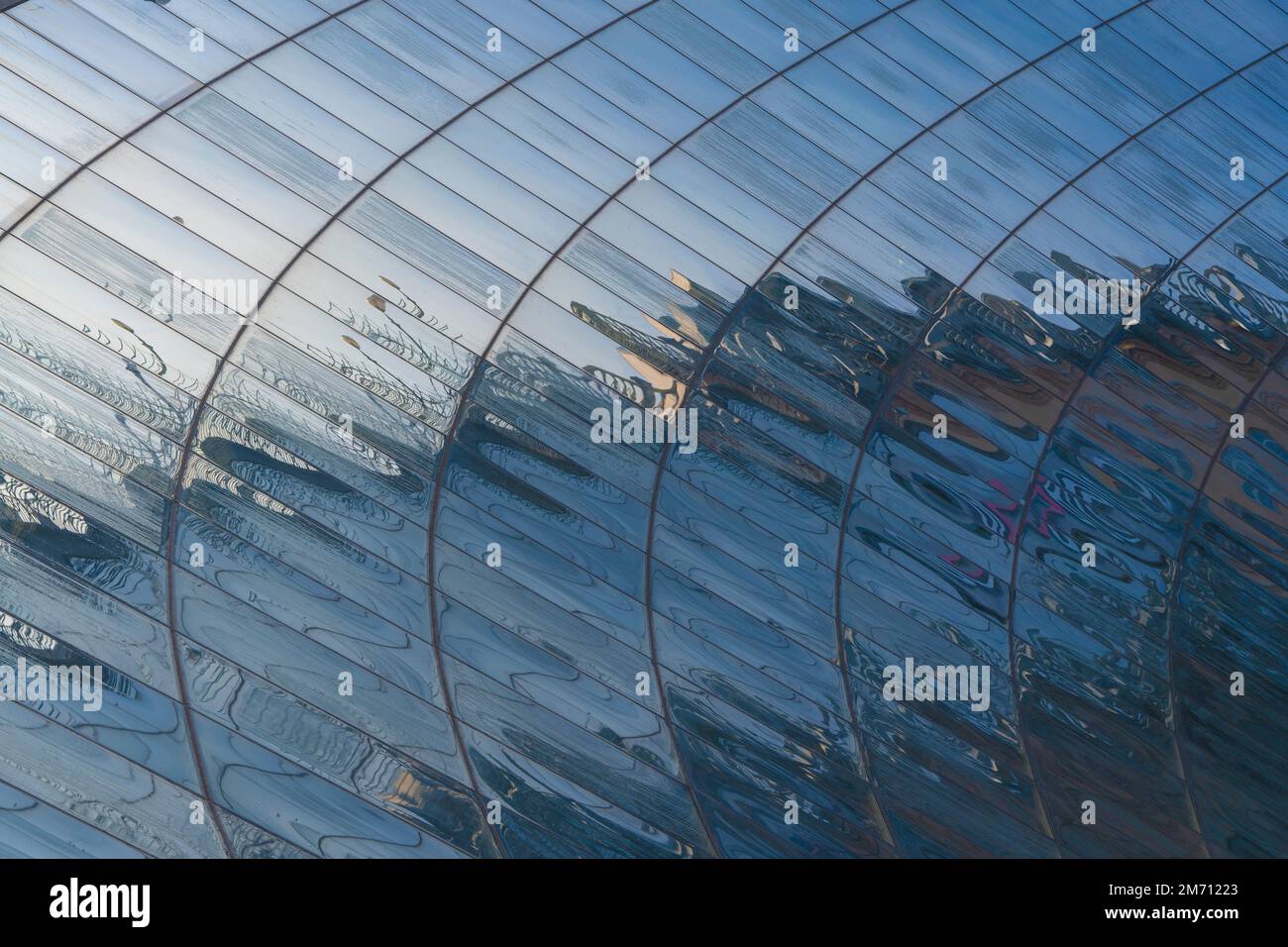 Modern office building facade. Tall business center with a glass facade ...