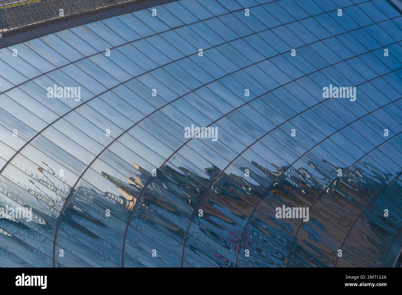 Modern office building facade. Tall business center with a glass facade ...