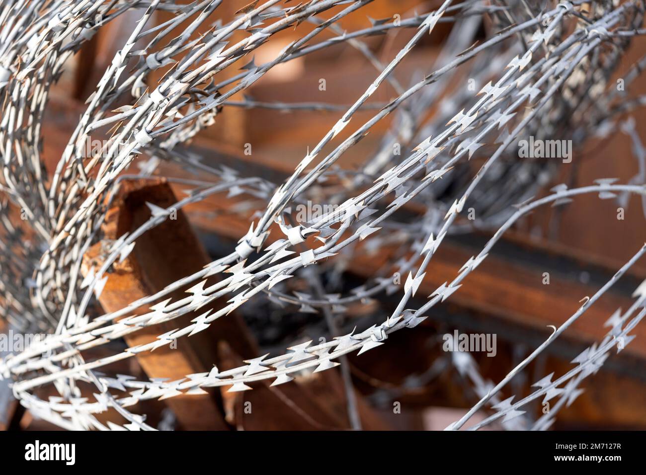 Barbed wire stretched over anti-tank hedgehogs. Fortified defense line ...