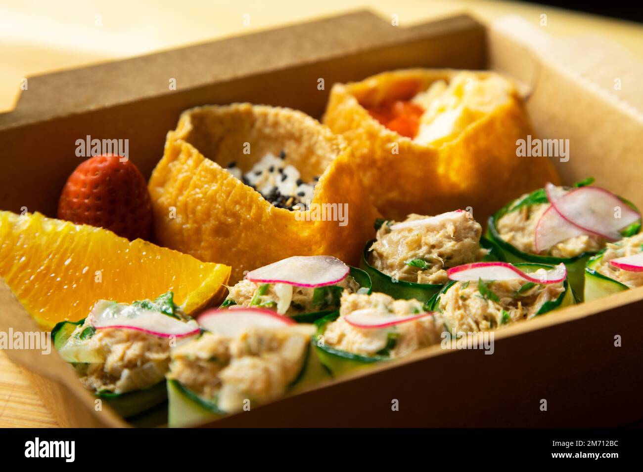 Japanese lunch box with yakisoba noddles, nigiris sushi, stuffed tofu ...