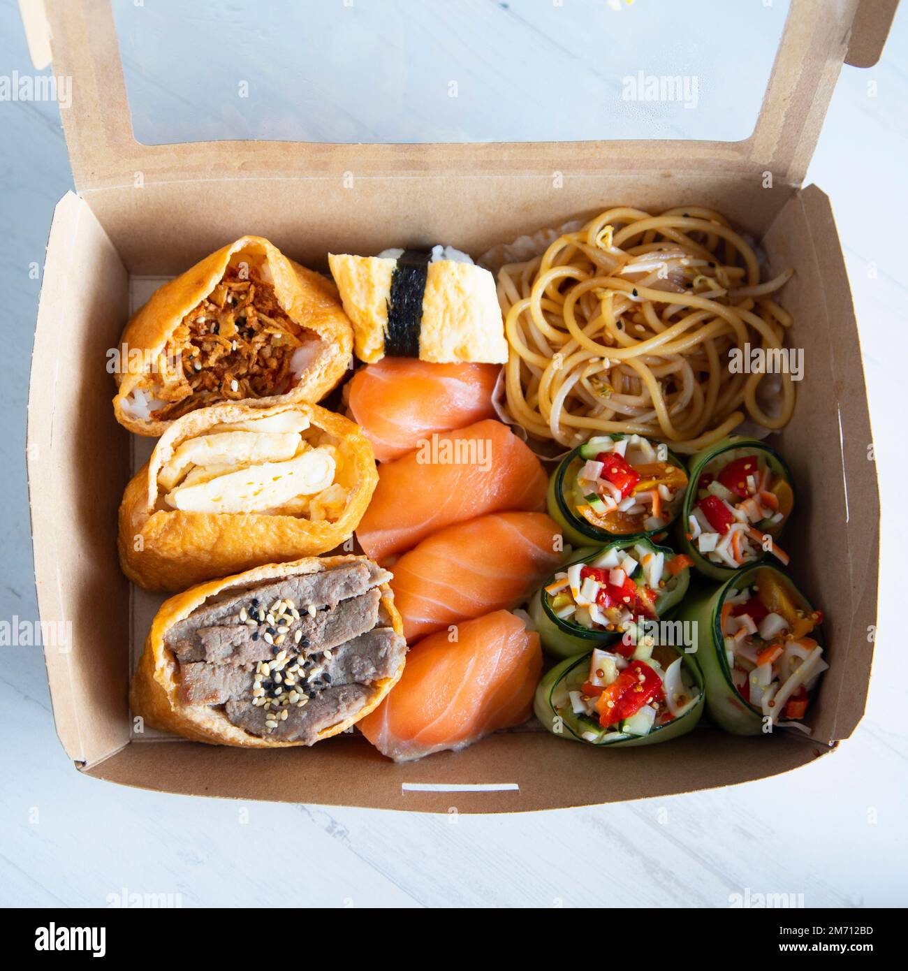 Japanese lunch box with yakisoba noddles, nigiris sushi, stuffed tofu ...