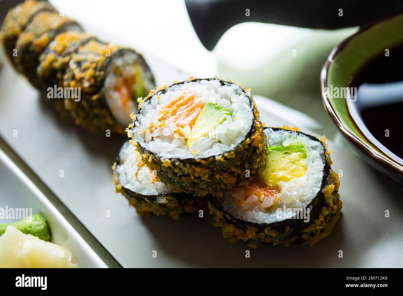 Salmon hot roll. Sushi roll stuffed with salmon and fried whole with ...
