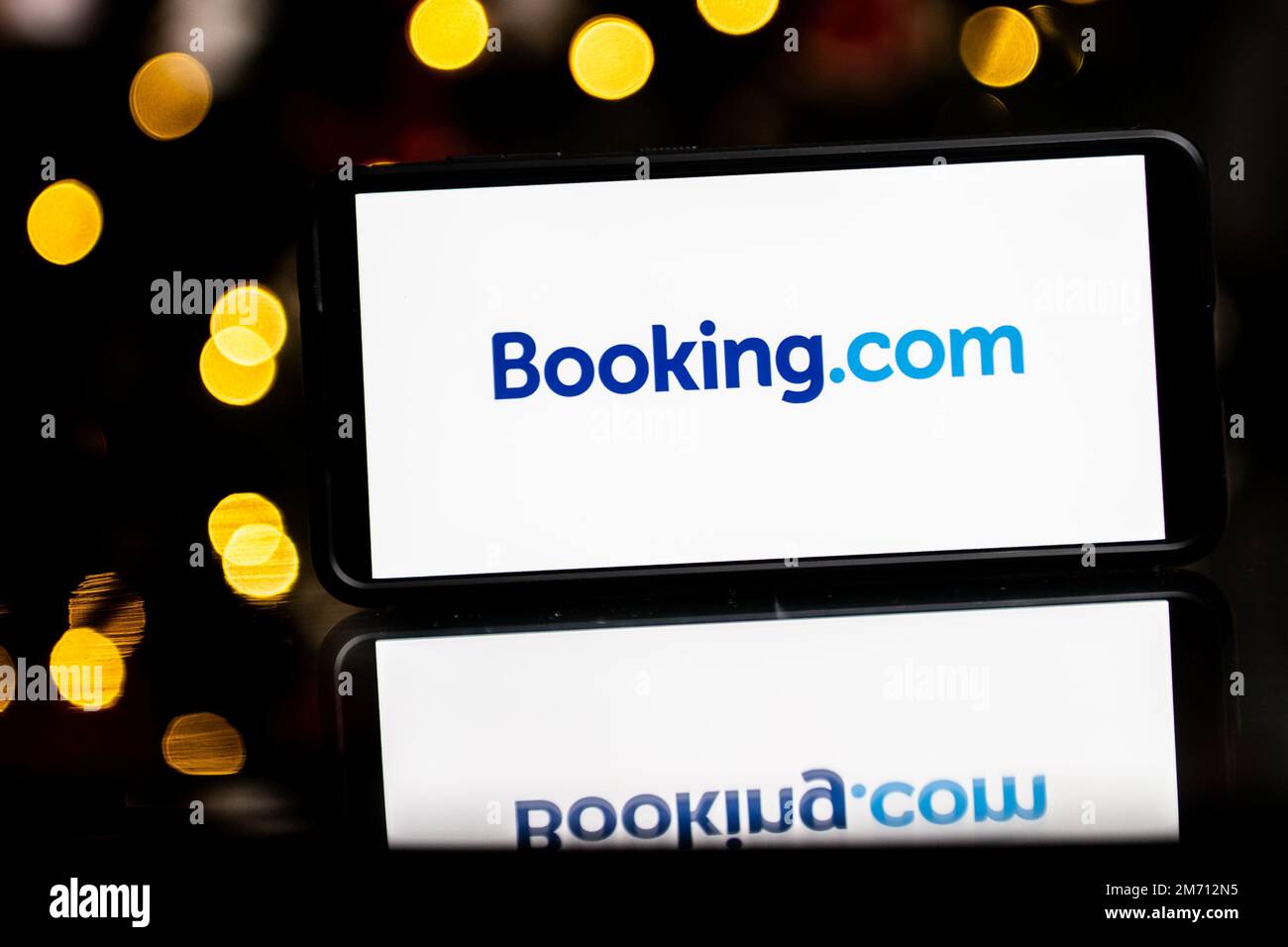 In this photo illustration a Booking.com logo seen displayed on a ...