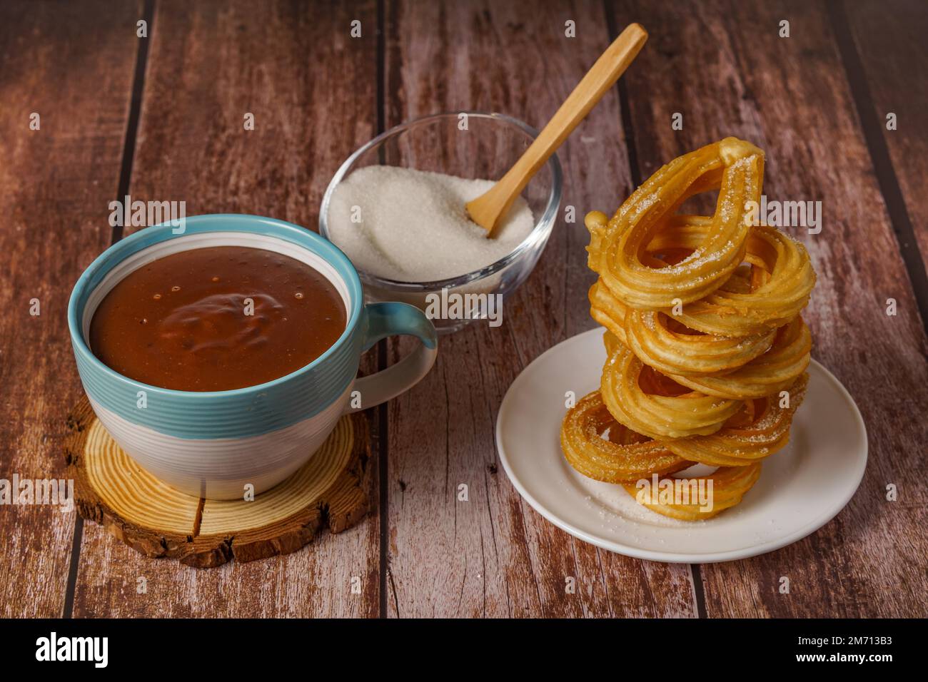 Hot chocolate with churros in a white and blue cup, typical spanish ...