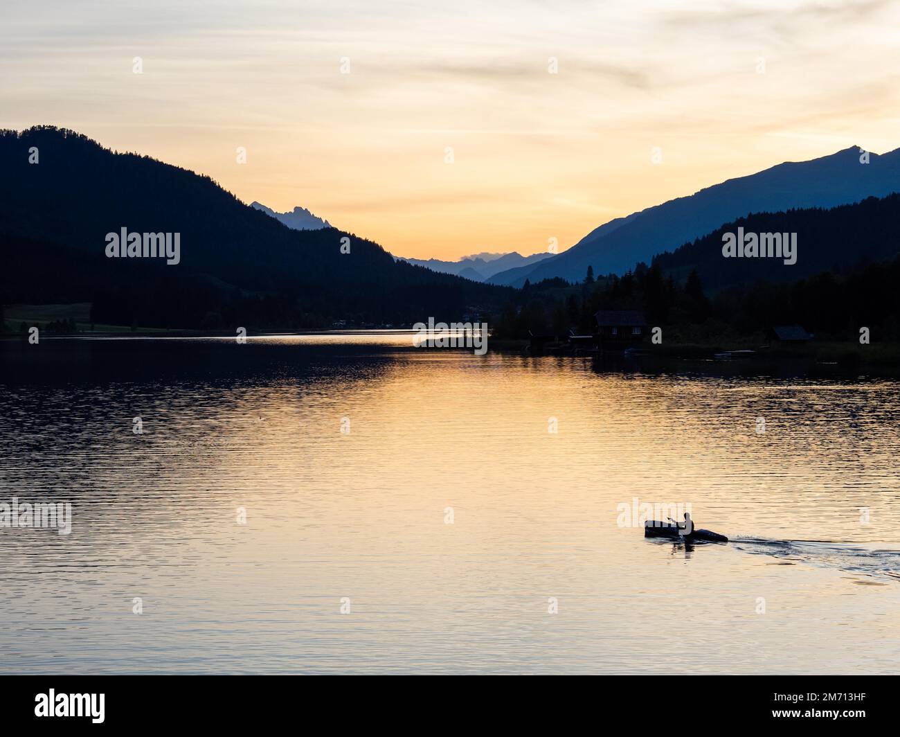 Evening atmosphere at sunset at Lake Weissensee, highest bathing lake ...