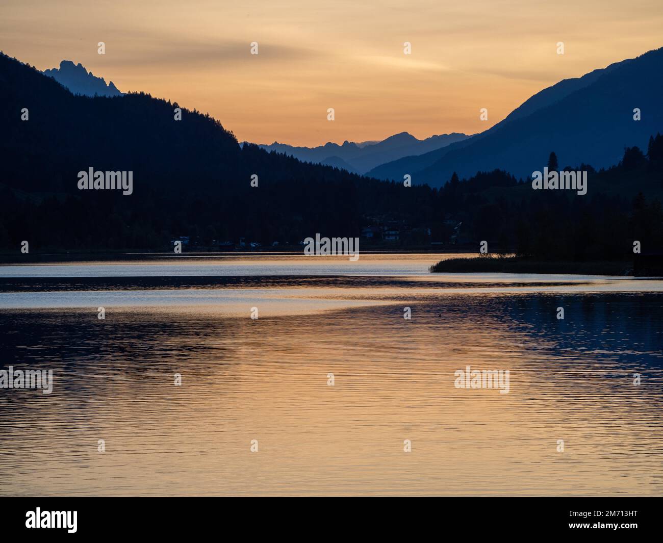 Evening atmosphere at sunset at Lake Weissensee, highest bathing lake ...