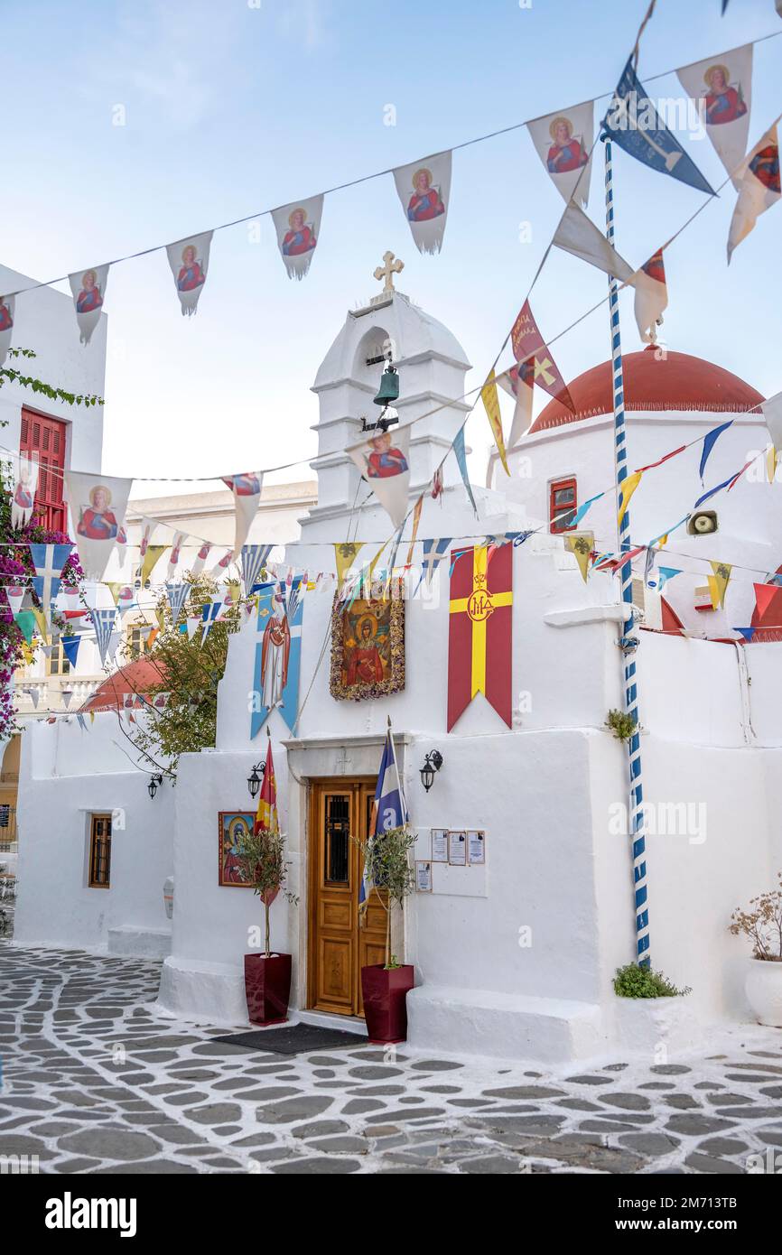 Cycladic Greek Orthodox Church decorated with flags, alleys of the old ...