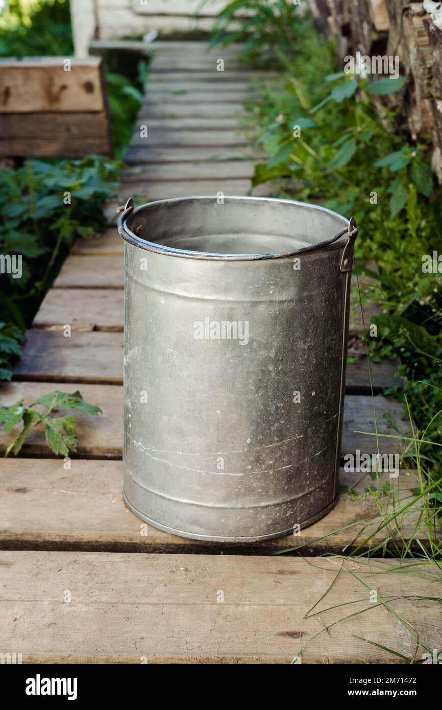iron bucket with water in the country in the summer Stock Photo - Alamy