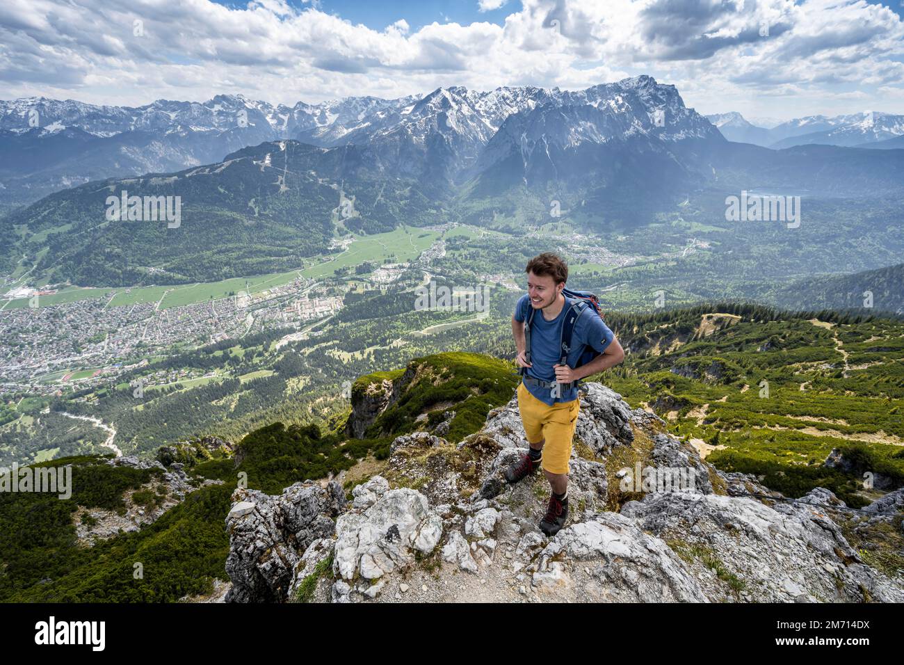 Hiker, summit of the Kramerspitz, Zugspitze in the back, Bavaria ...