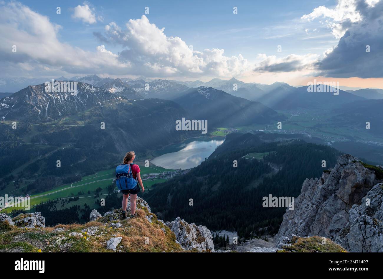 Evening atmosphere, mountaineer at the summit of Schartschrofen looking ...