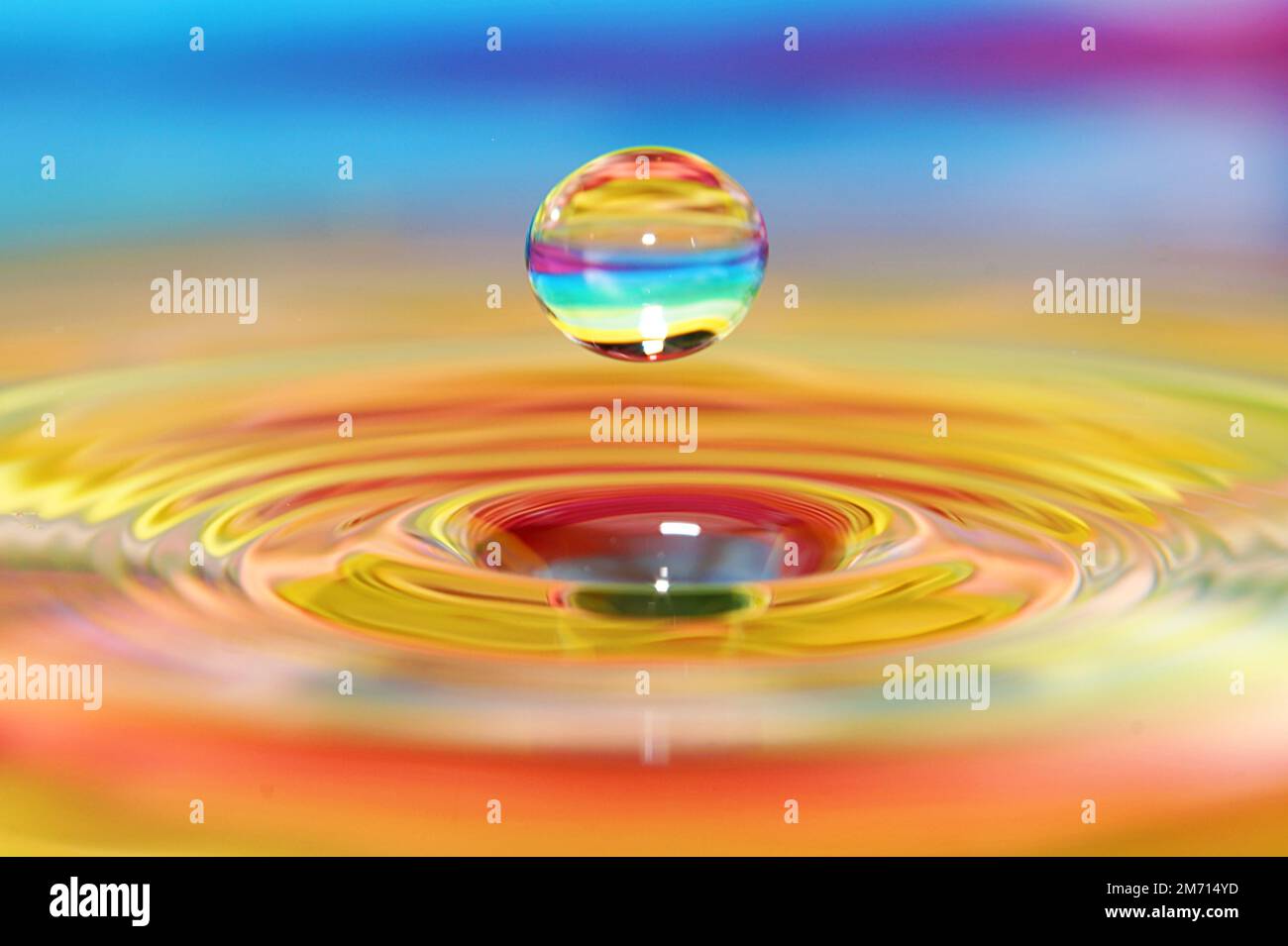 A Rainbow Colored waterdrop with round in water Stock Photo - Alamy