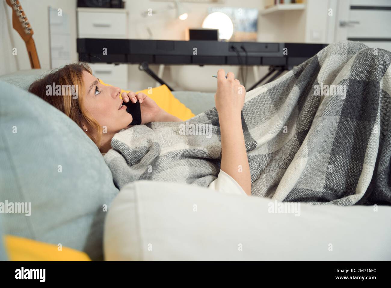 Ill woman making phone call in her bed Stock Photo - Alamy