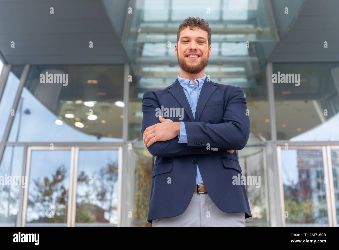 Portrait businessman CEO of a company at glass office entrance, finance ...