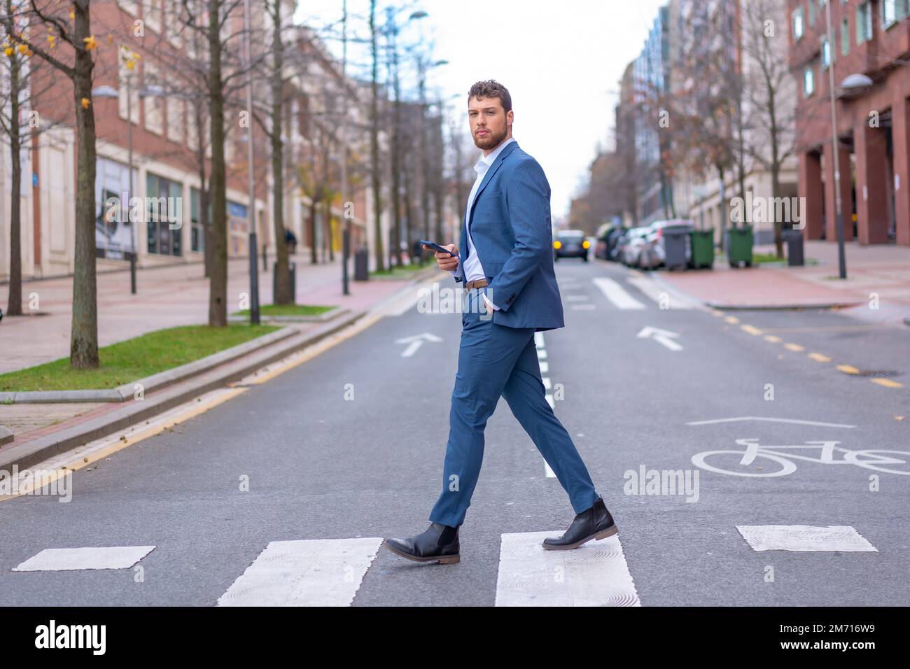 Businessman or finance man crossing a zebra crossing heading to the ...