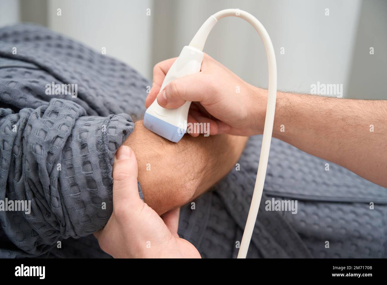 Skilled orthopaedist perfroming ultrasound therapy of an elbow Stock ...