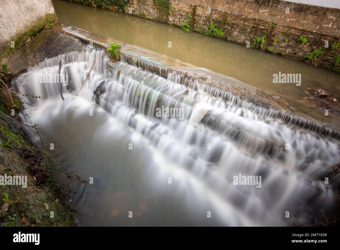 Long exposure of a watefall on the River Lim walkway at Lyme Regis in ...