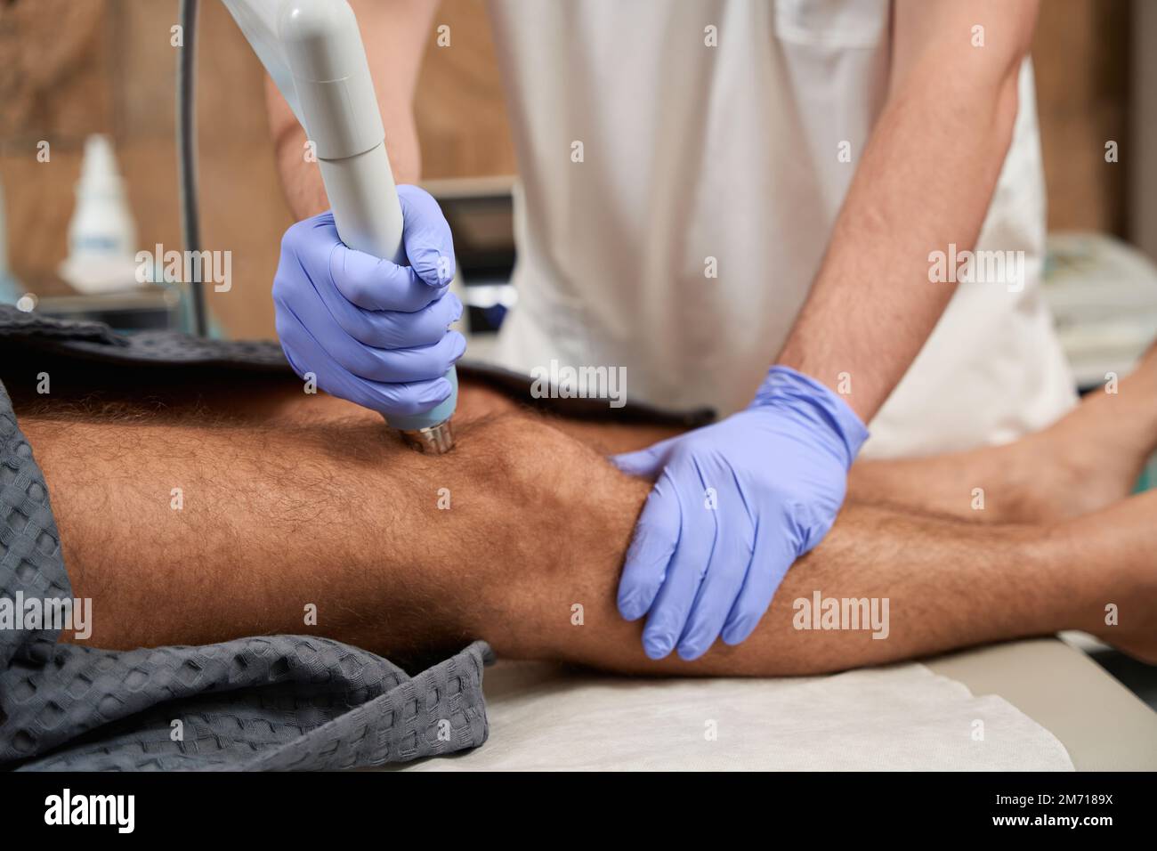 Progressive medic doing the radiofrequency therapy procedure at clinic ...